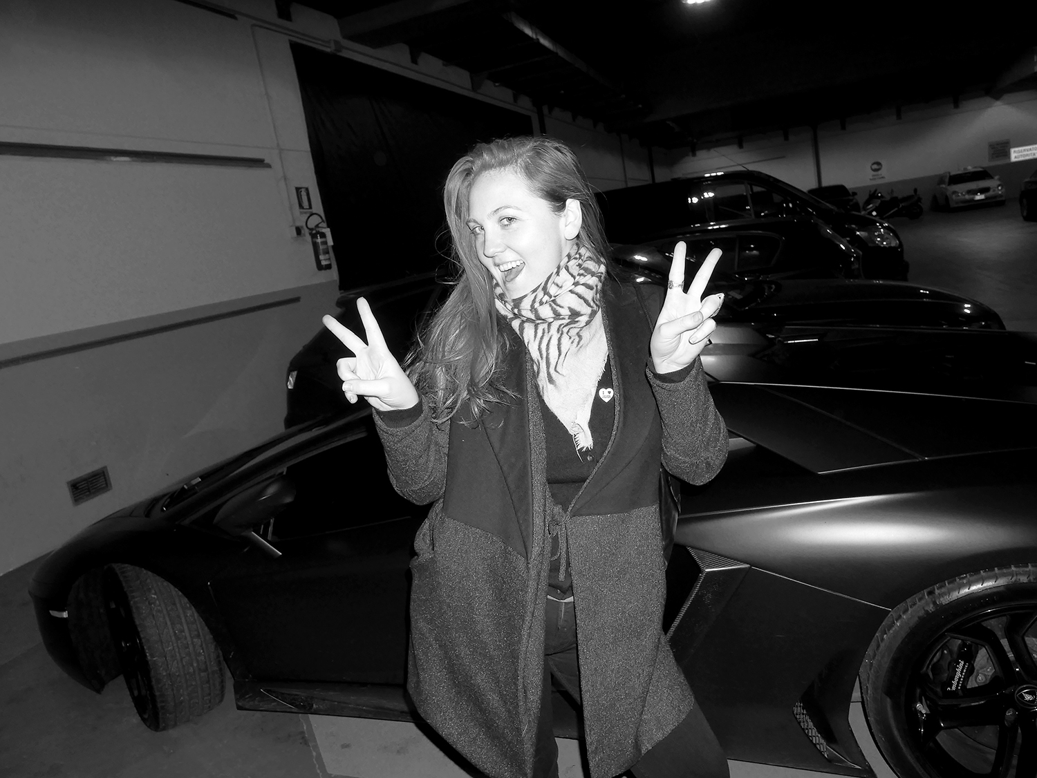 Caroline Gaimari in front of the black Lamborghini, Milan. Photo ...